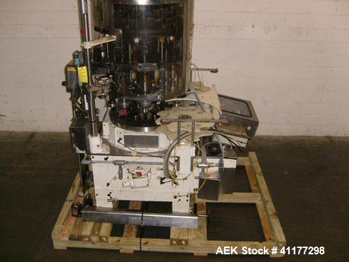 Used Pneumatic Scale 8 Head Rotary Chuck Capper. Capable of speeds up