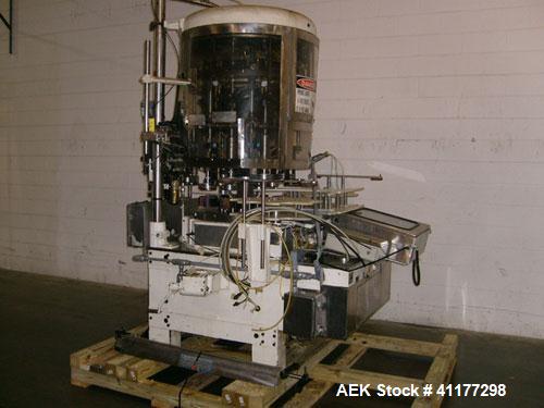 Used Pneumatic Scale 8 Head Rotary Chuck Capper. Capable of speeds up