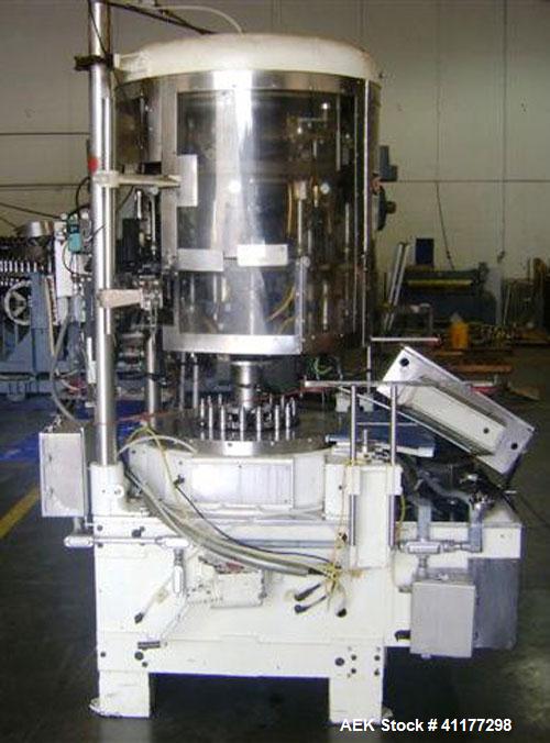 Used Pneumatic Scale 8 Head Rotary Chuck Capper. Capable of speeds up