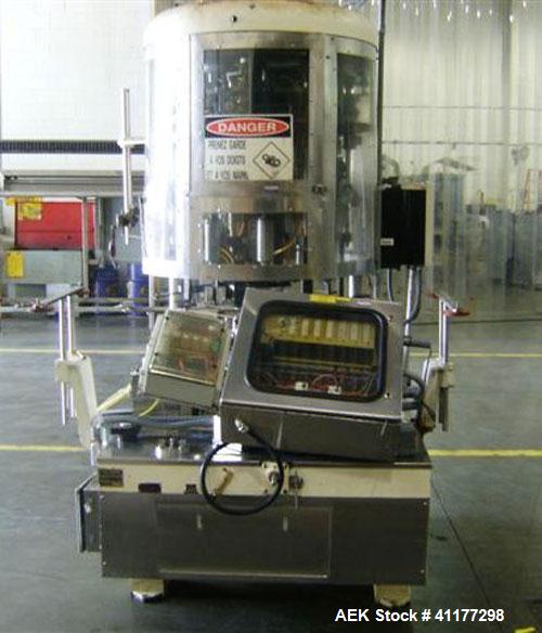 Used Pneumatic Scale 8 Head Rotary Chuck Capper. Capable of speeds up