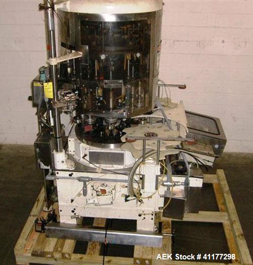 Used Pneumatic Scale 8 Head Rotary Chuck Capper. Capable of speeds up