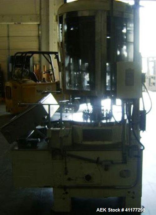 Used Pneumatic Scale 8 Head Rotary Chuck Capper. Capable of speeds up