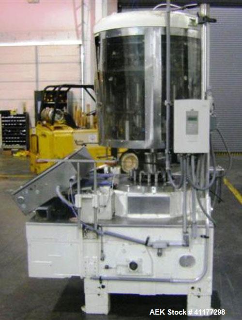 Used Pneumatic Scale 8 Head Rotary Chuck Capper. Capable of speeds up