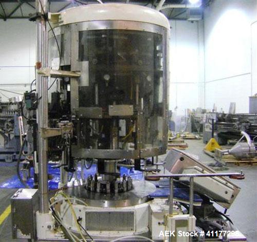 Used Pneumatic Scale 8 Head Rotary Chuck Capper. Capable of speeds up