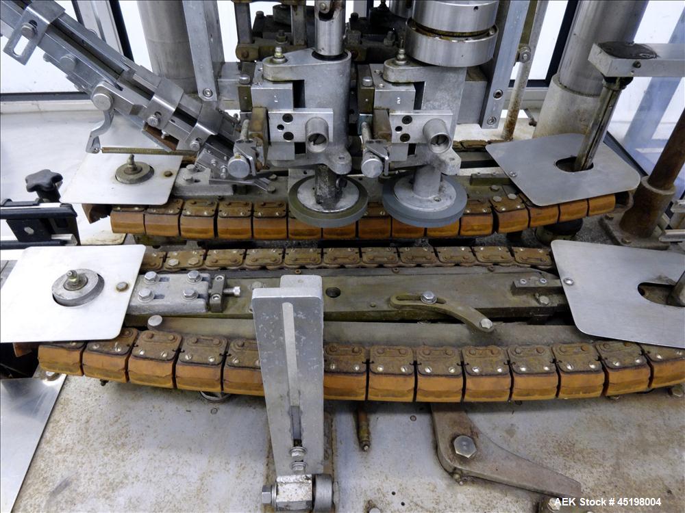 Used Resina Model UN 20 Quill Capper. Capable of speeds up to 100 cpm